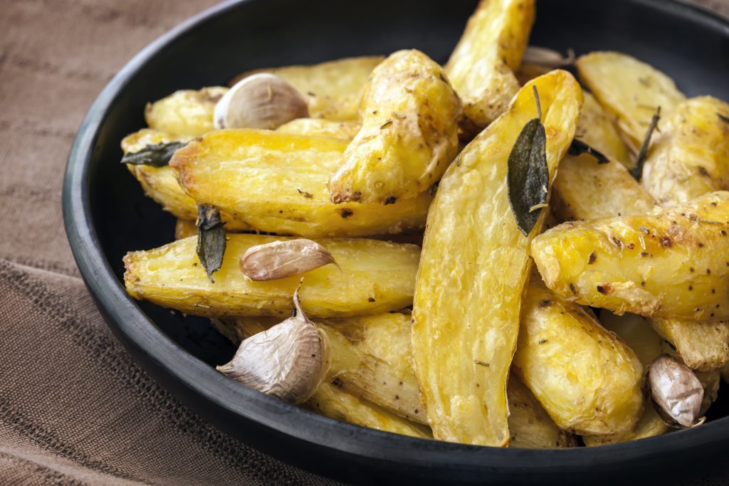 Roasted fingerling or kipfler potatoes, with sage leaves, in bla ...